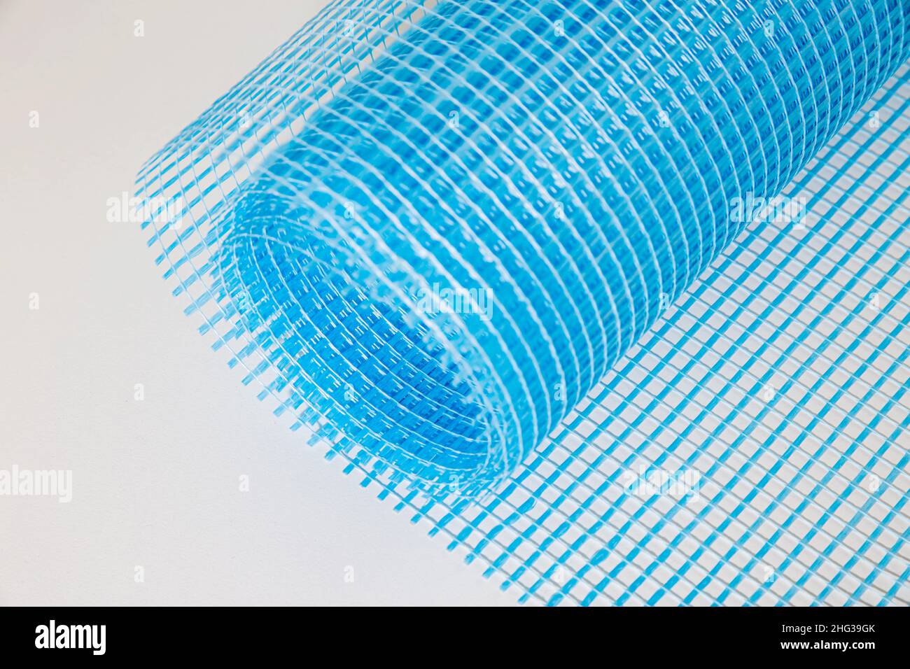 Blue reinforcing construction mesh for wall strengthening on white ...