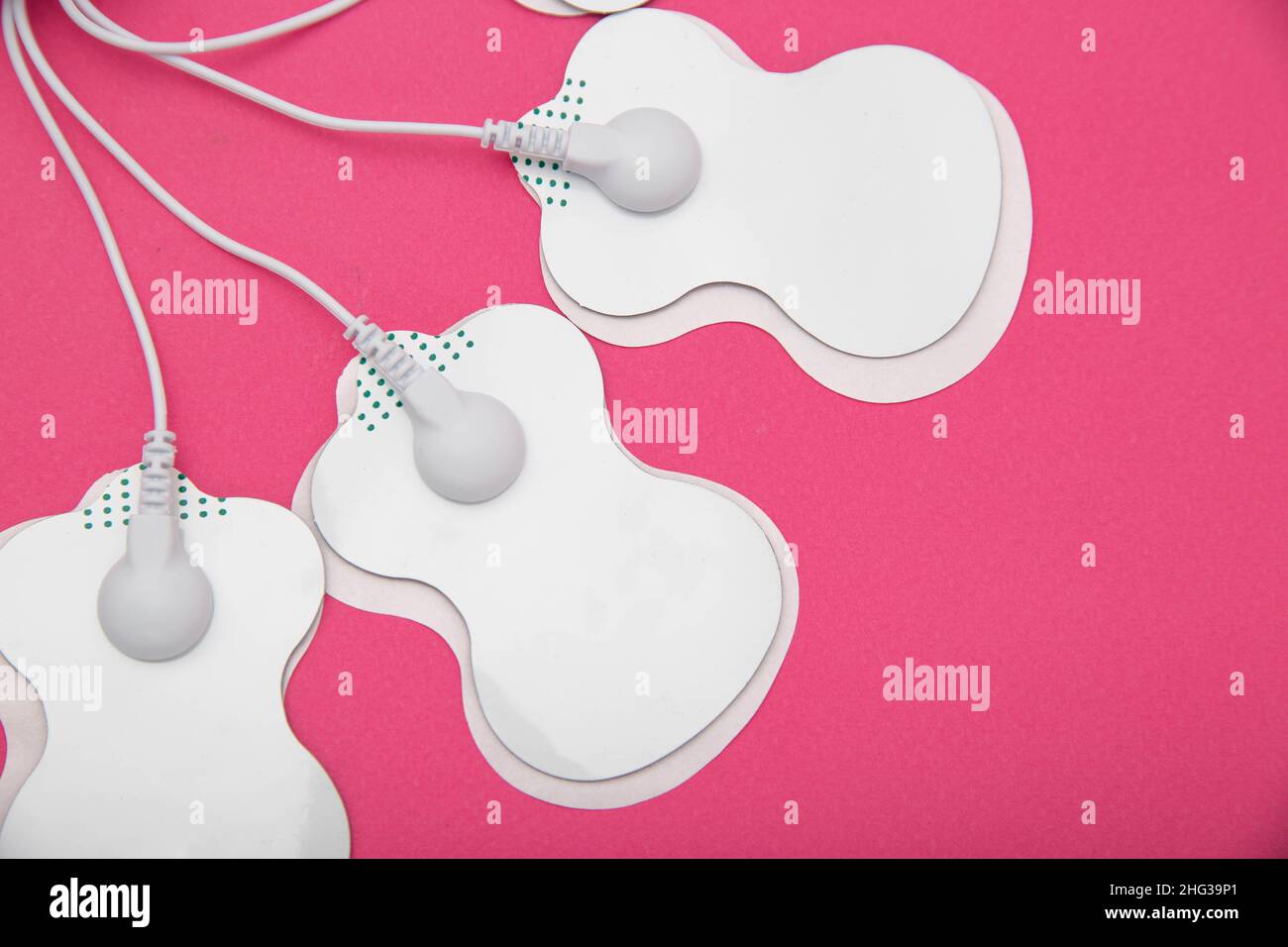 Electrical electrodes for stimulating the patient's body on a pink ...