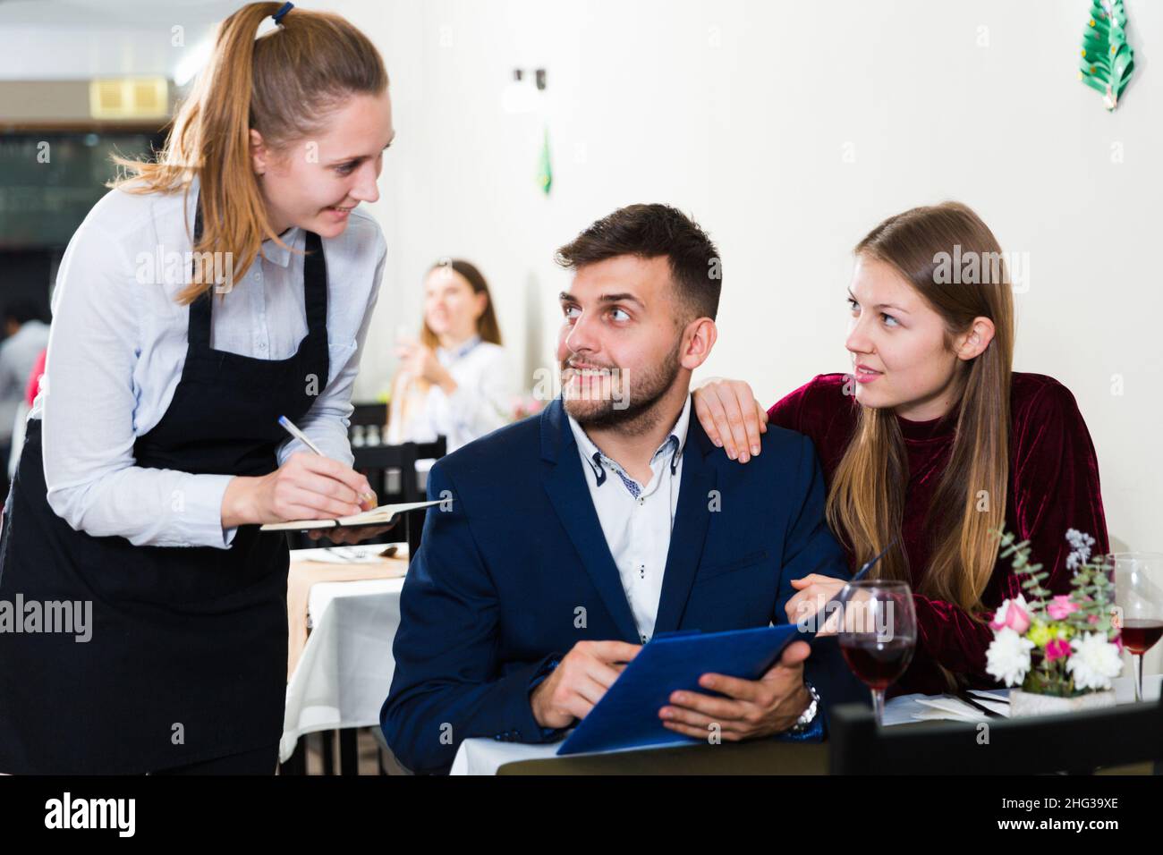 Couple is giving order to female waiter in luxury restaurante Stock ...