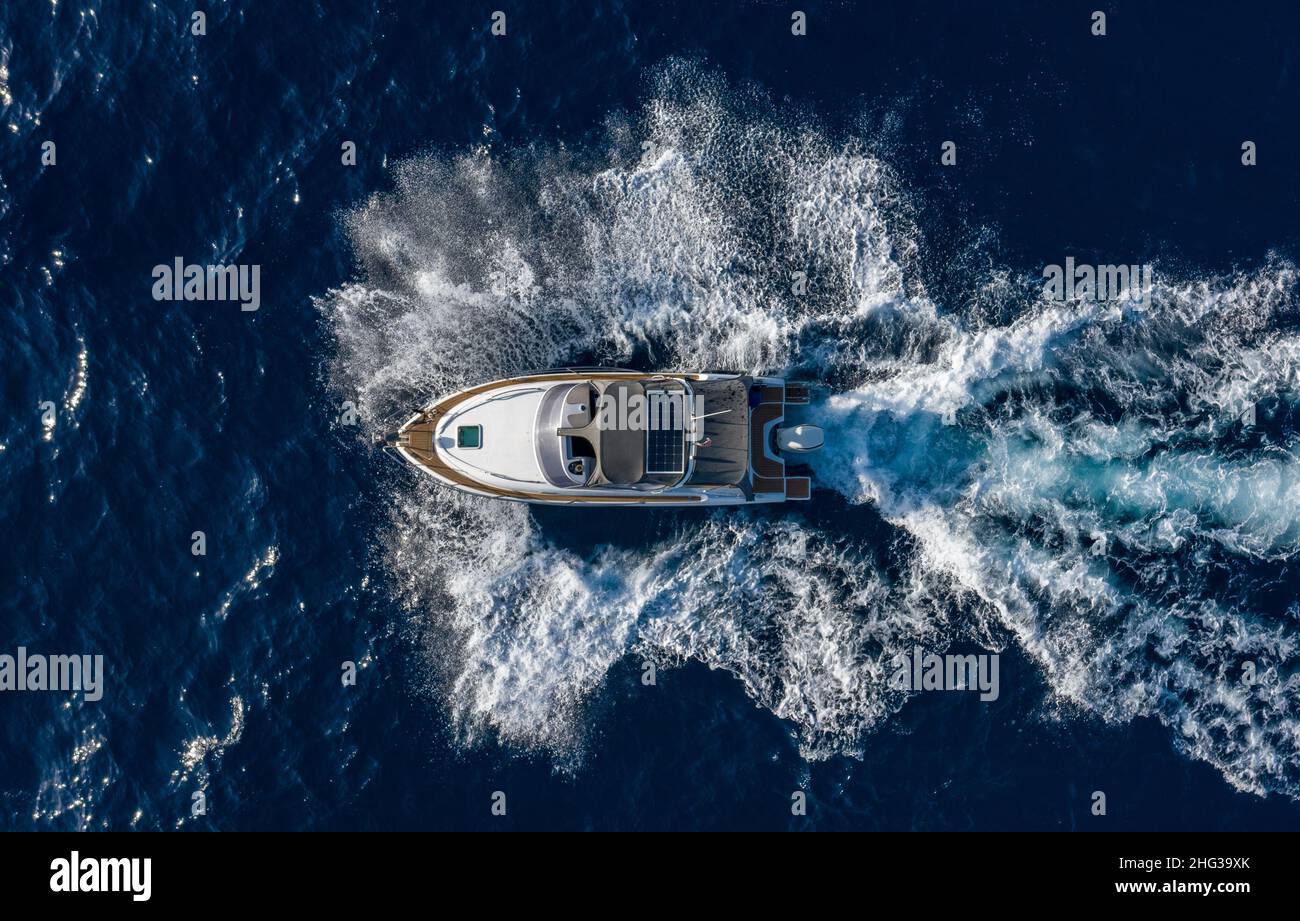 Boating, boat breaking waves shot from drone Stock Photo - Alamy