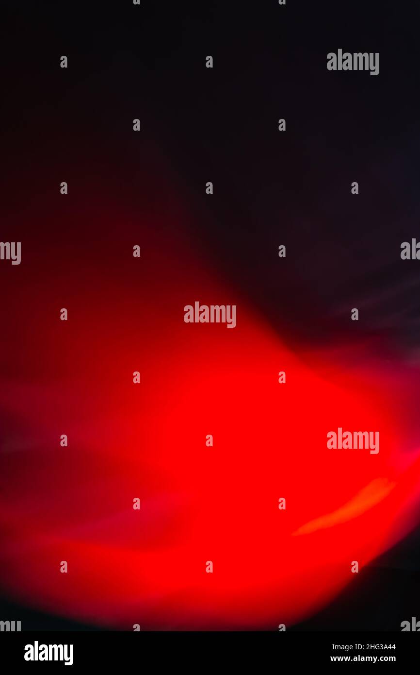 Vertical black background with bright red glow waves and highlights ...