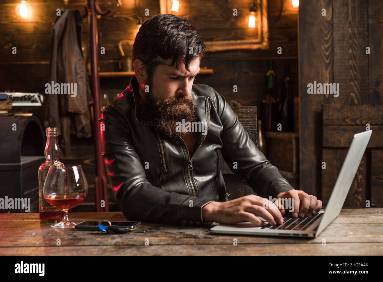 Alcoholic businessman drinking whiskey working at laptop. Sad man ...