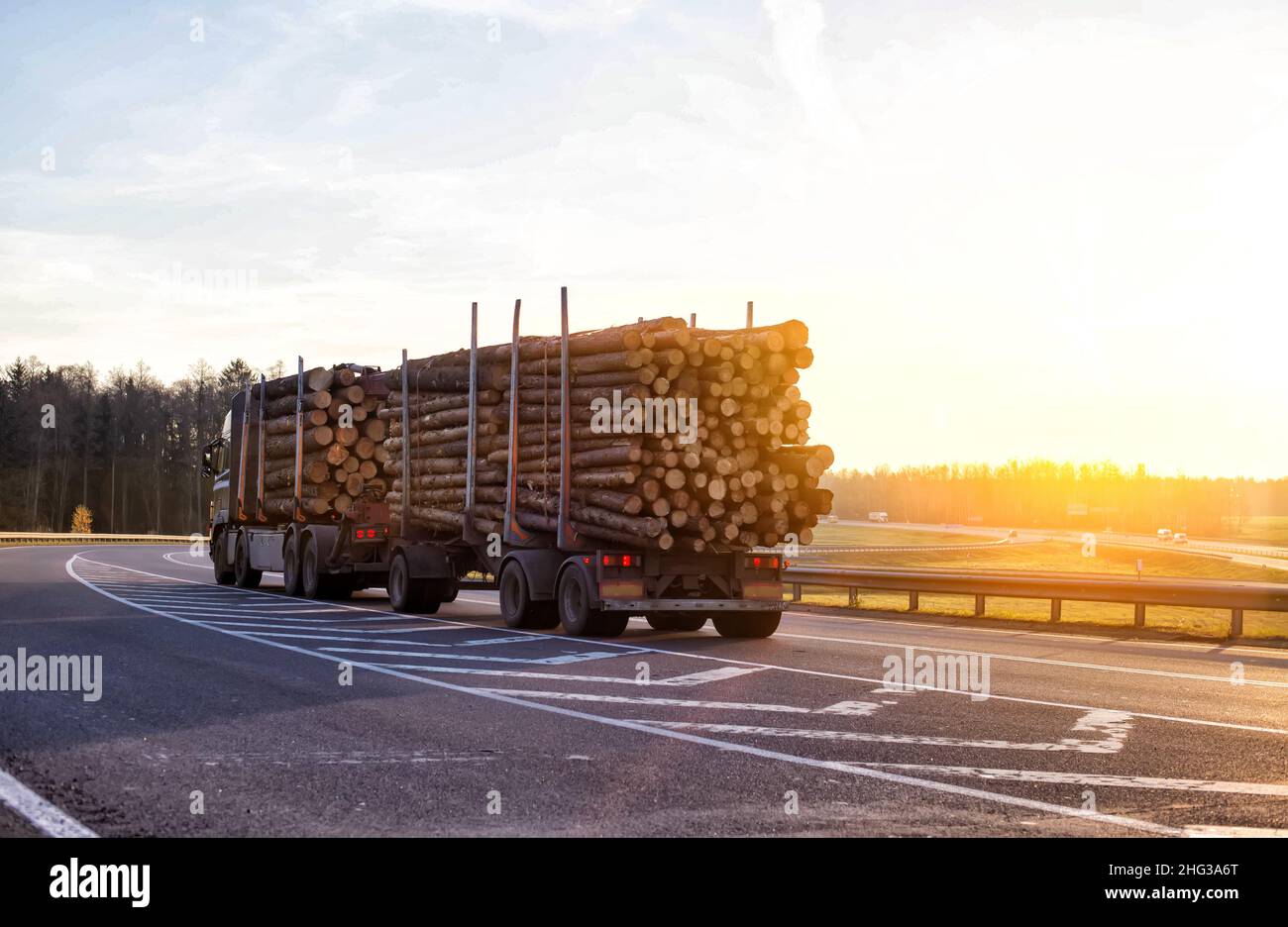 Timber truck with a trailer to transport long timber logs along the ...