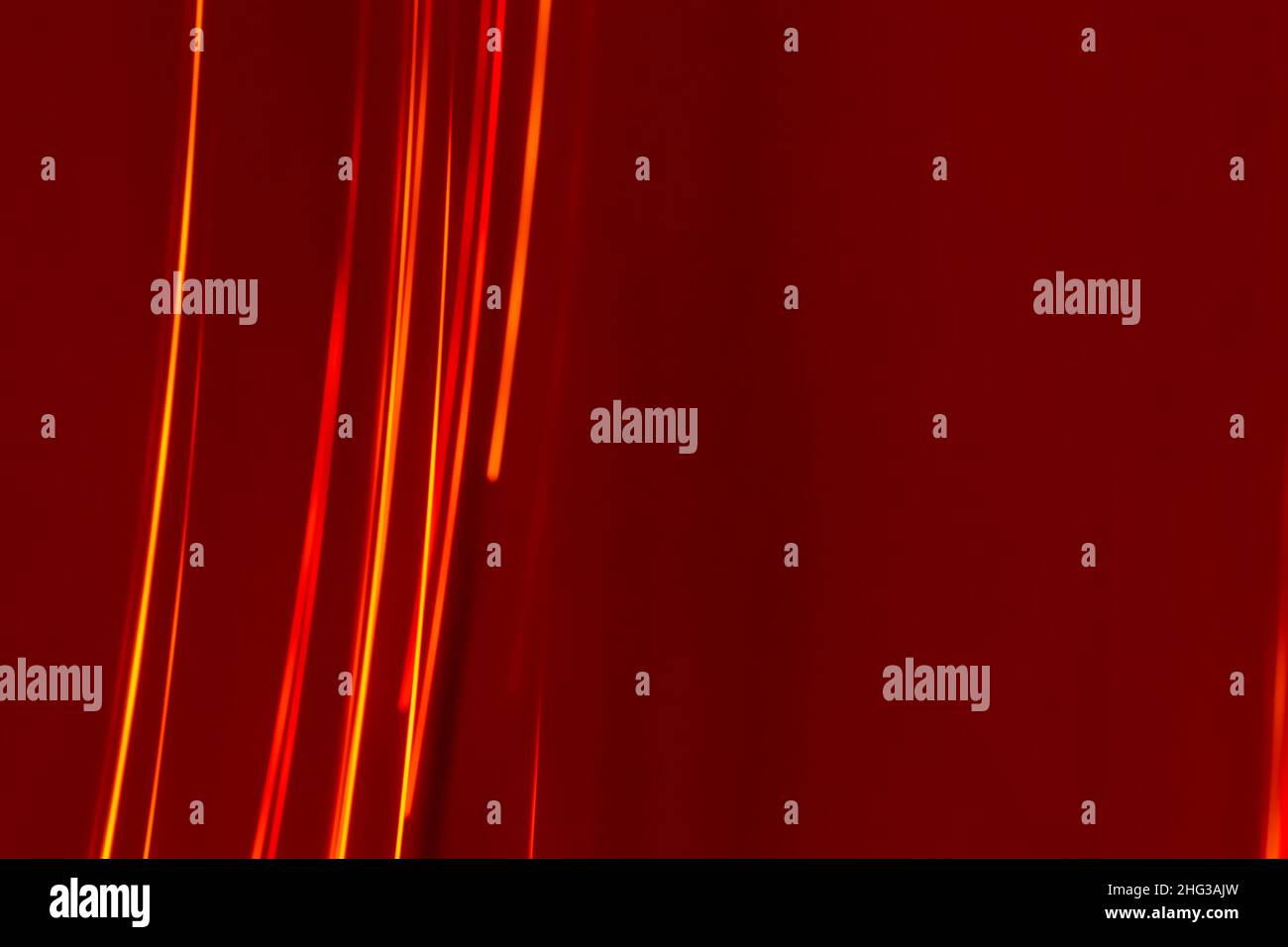Bright red lines rays on a burgundy background. Abstract backdrop with ...