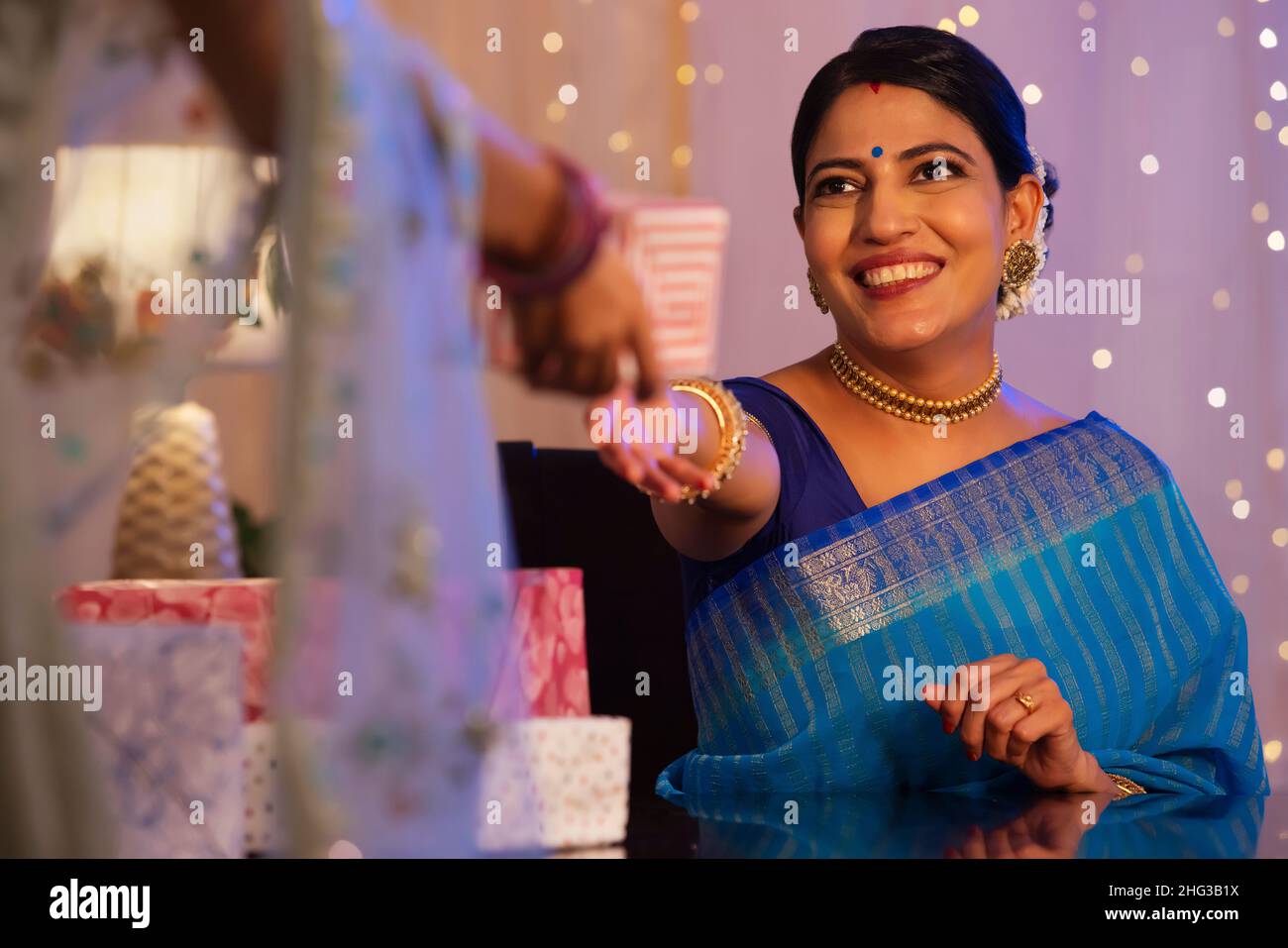 Woman taking gift from her daughter on the occasion of Diwali Stock ...