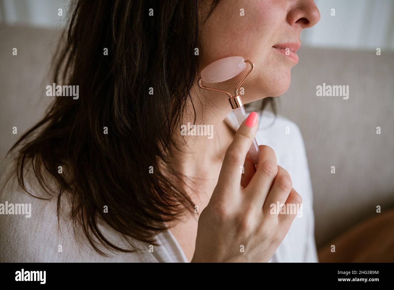 Portrait of beauty woman skin care, brunette girl use roller on healthy ...
