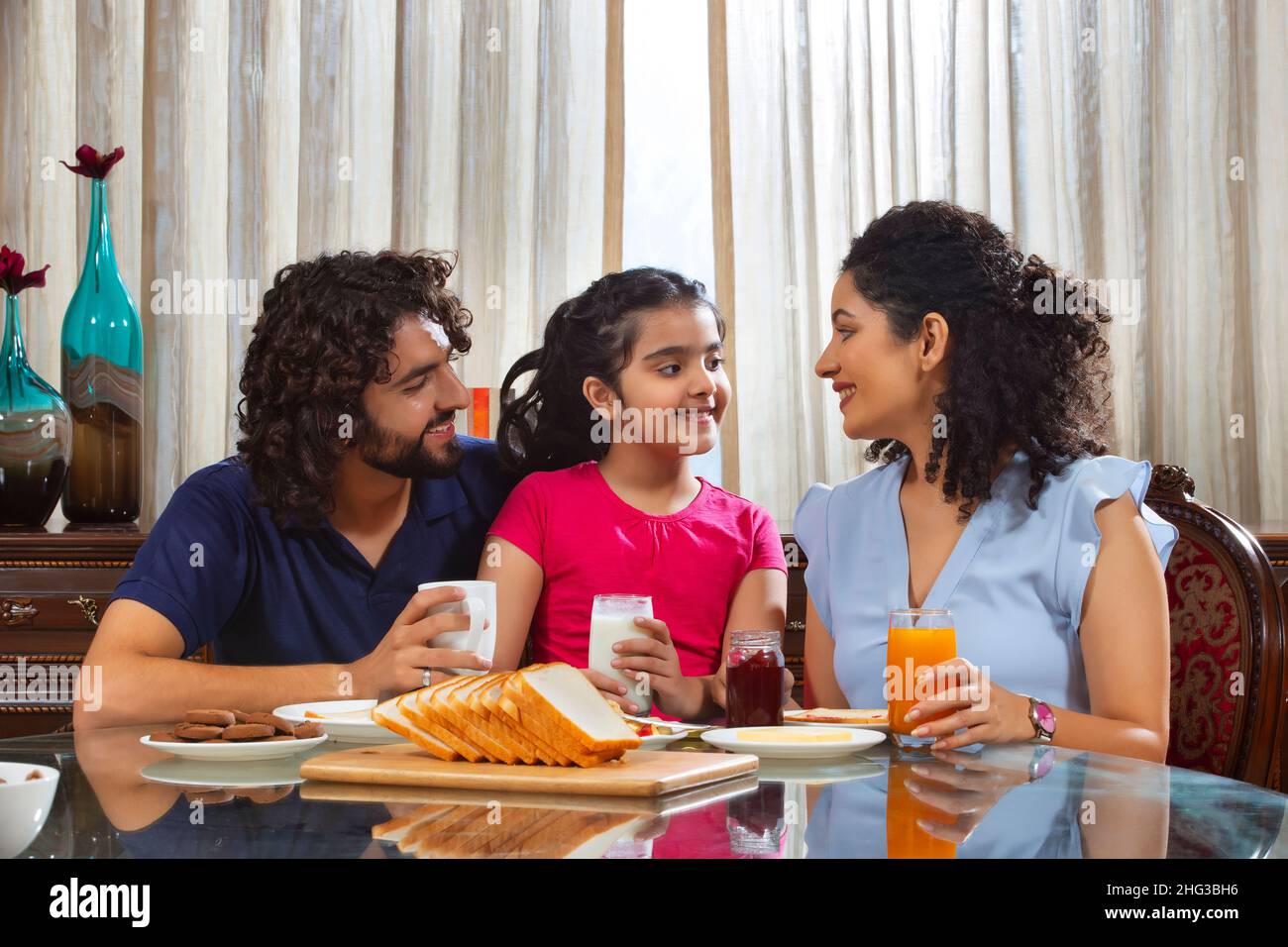 Family members sharing an intimate moment at the breakfast table in the ...