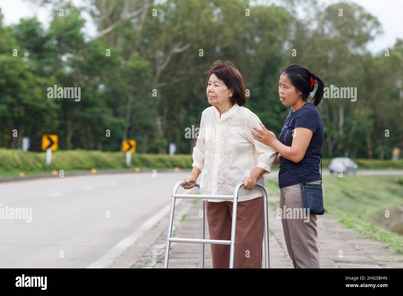 senior woman using a walker cross street Stock Photo - Alamy