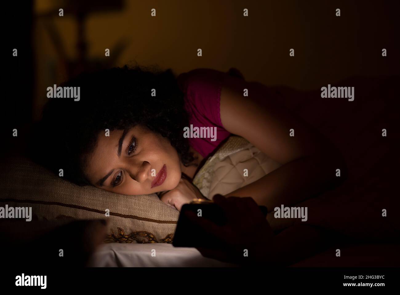 Woman lying on bed watching hi-res stock photography and images - Alamy
