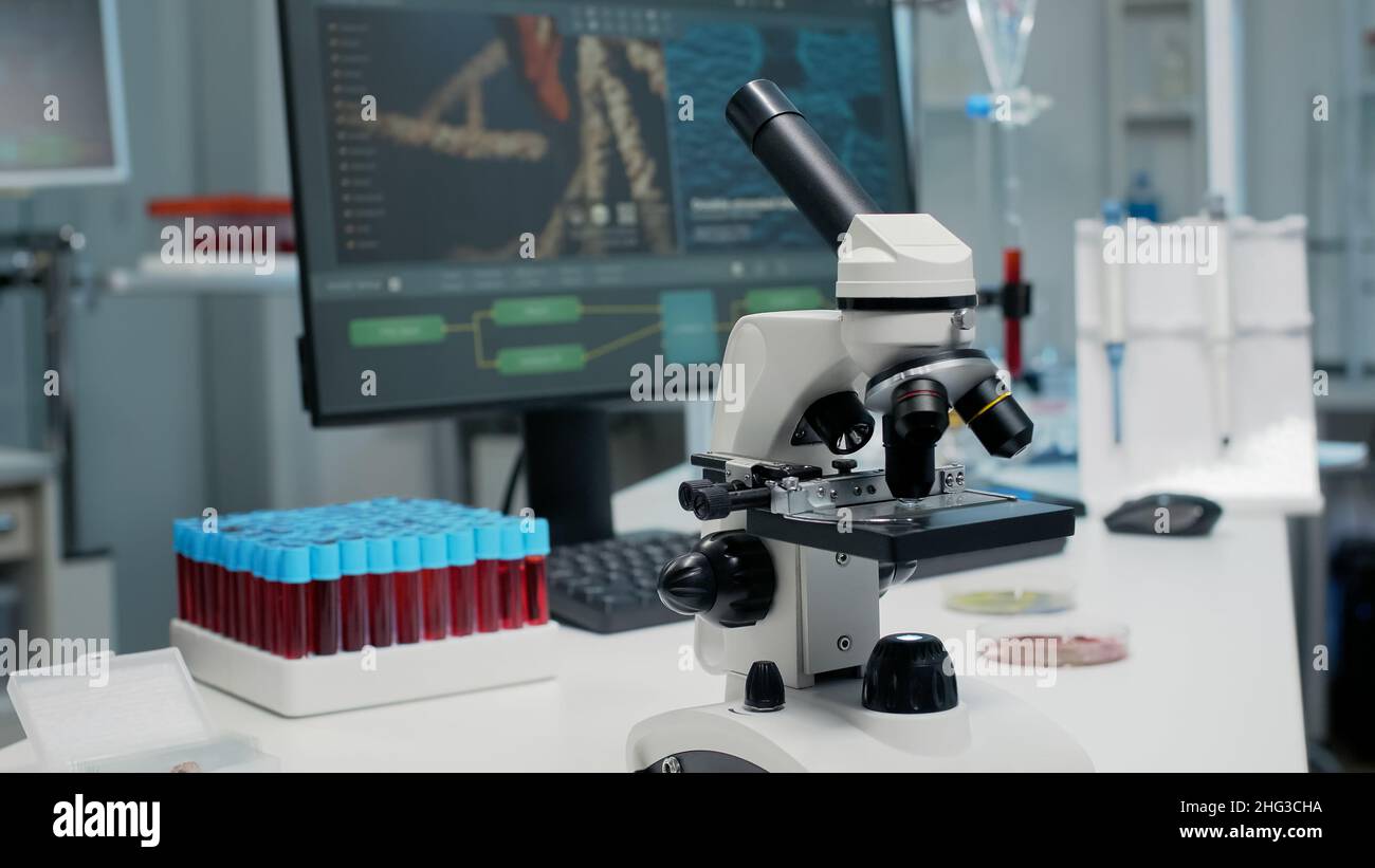 Close up of laboratory microscope on desk with medical research ...