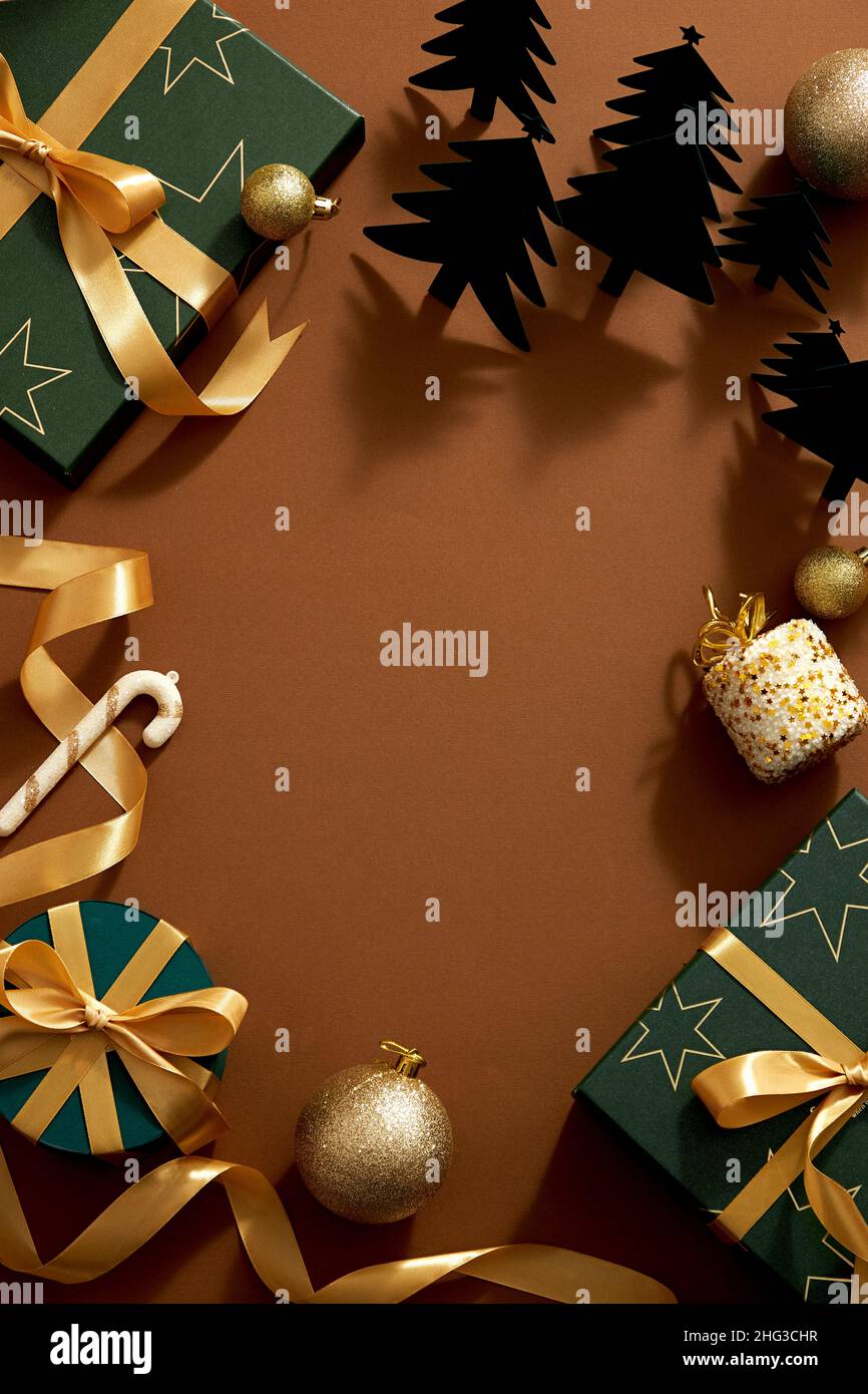 Top view of dark green christmas ornament in brown background , gift ...