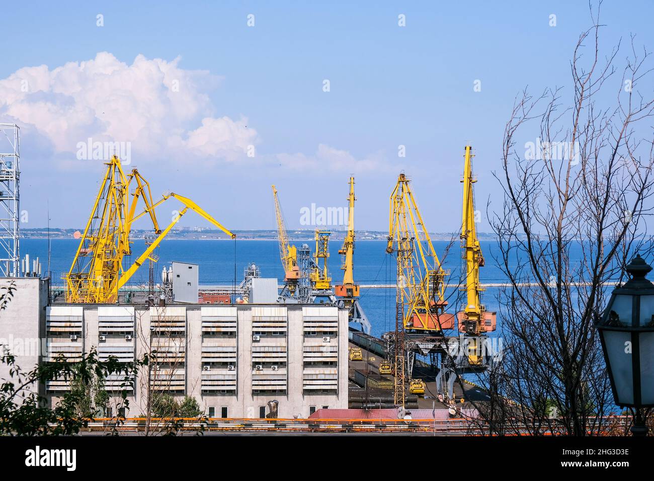 Bulk carrier ship under load of clinker cargo loading by shore cranes ...