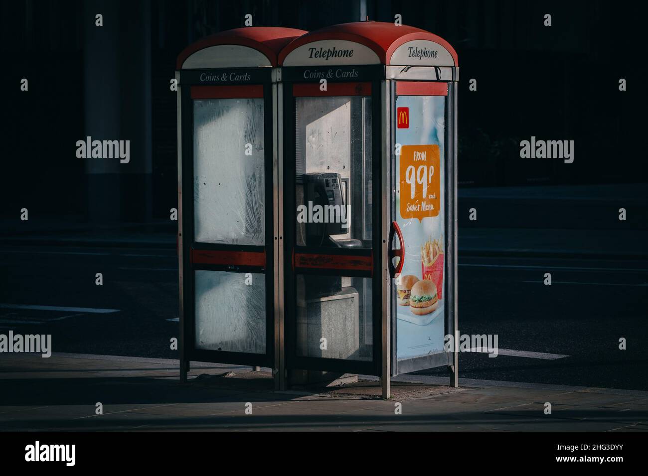 Two empty telephone boxes on a street in the City of London, England ...