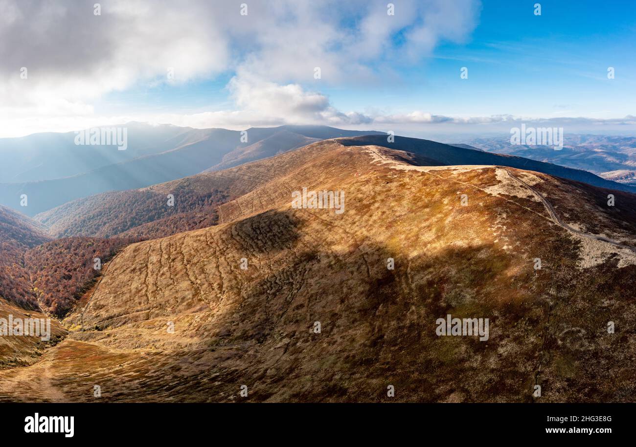 Long narrow pathways running along high mountain ridge under white ...