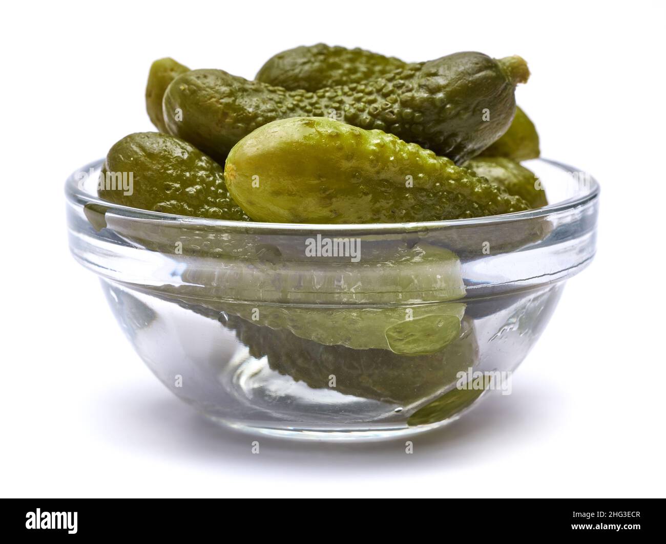 Bowl of Tasty canned Whole green cornichons isolated on a white ...