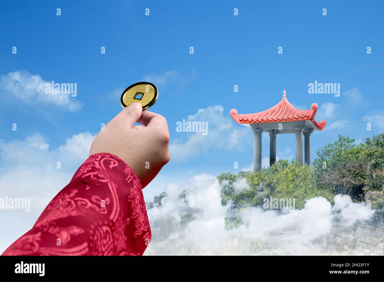 Hand holding golden Chinese coin with park background. Happy Chinese ...