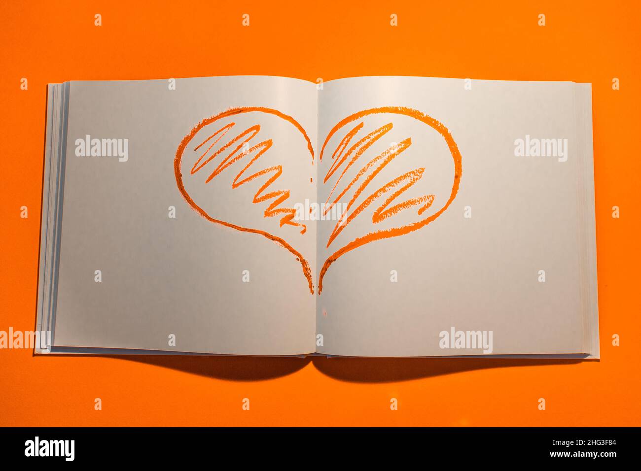 Drawn heart in a notebook on a yellow background. Happy Valentine's Day ...