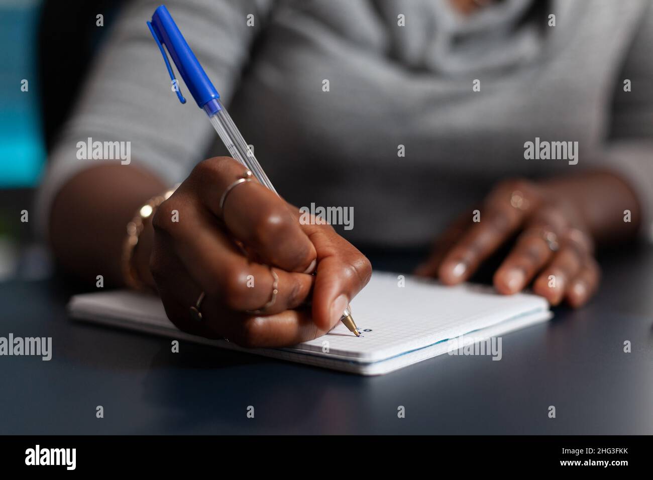 Close up of hand holding pen to write on textbook file, working from ...