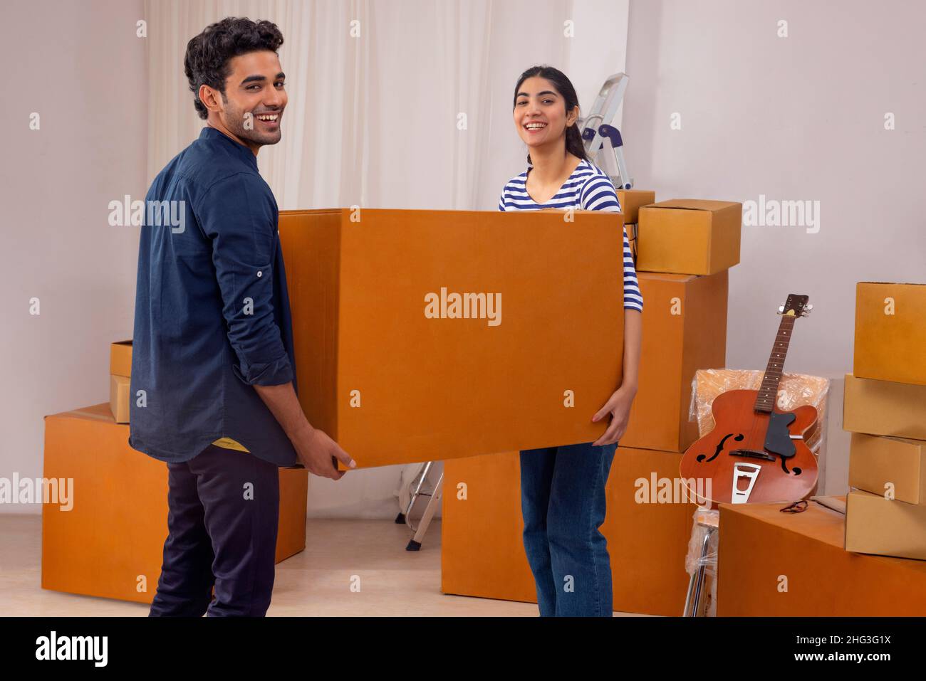 Adult boy and girl moving carton box house shifting Stock Photo - Alamy