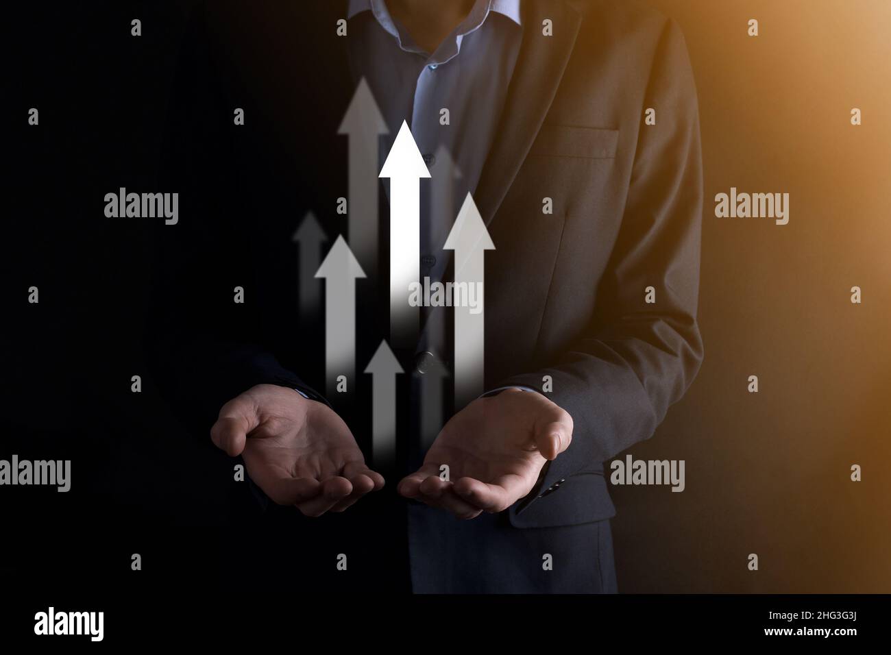 Business man holding holographic graphs and stock market statistics ...
