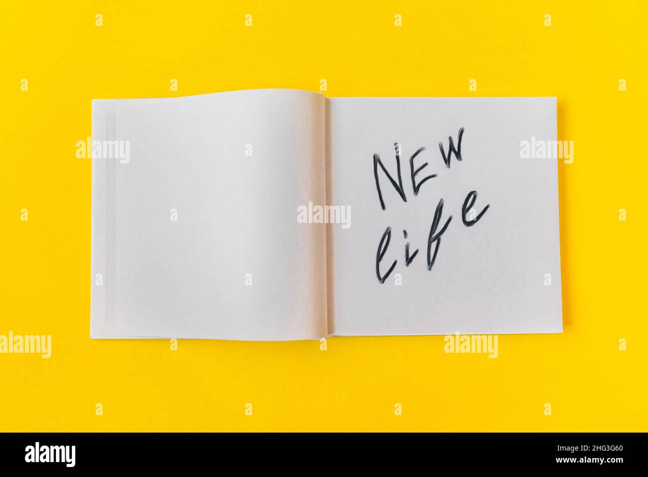 New life. Notepad with blank pages on a yellow background Stock Photo ...