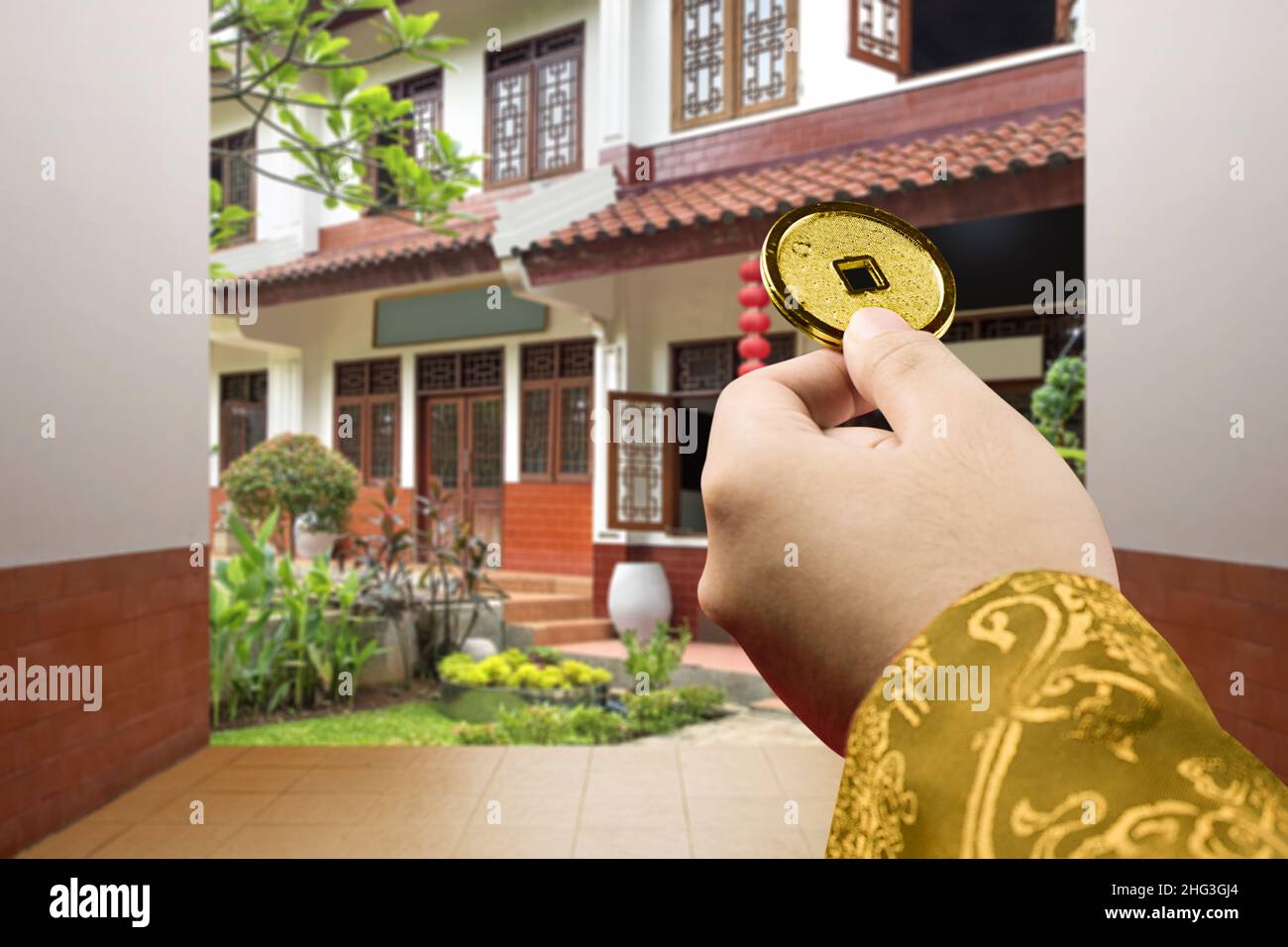 Hand holding golden Chinese coin with park background. Happy Chinese ...