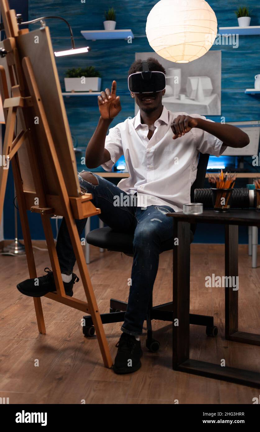 Young artist wearing virtual reality headset imagining draw sketch ...