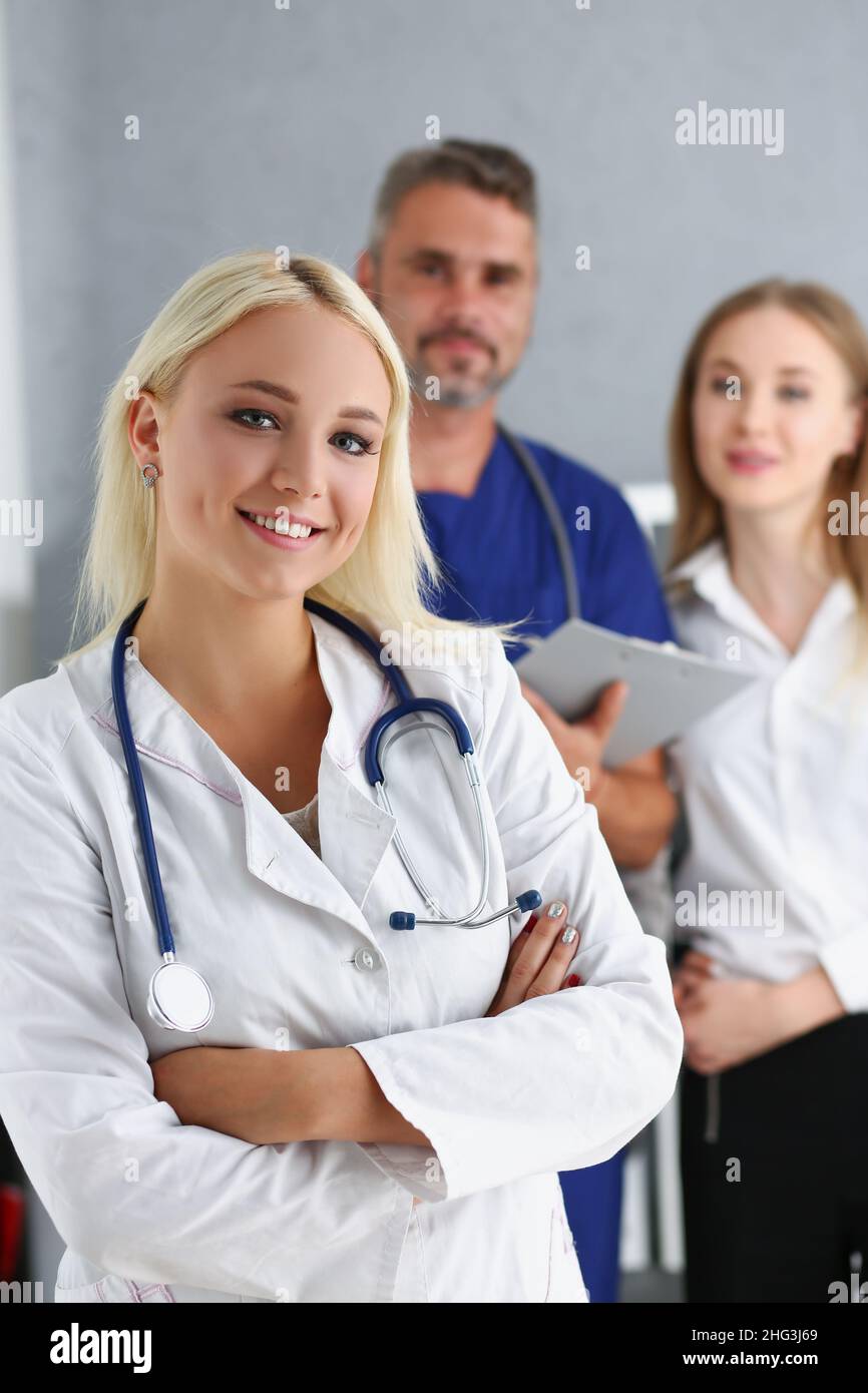Young smiling woman start full working day in clinic after internship ...