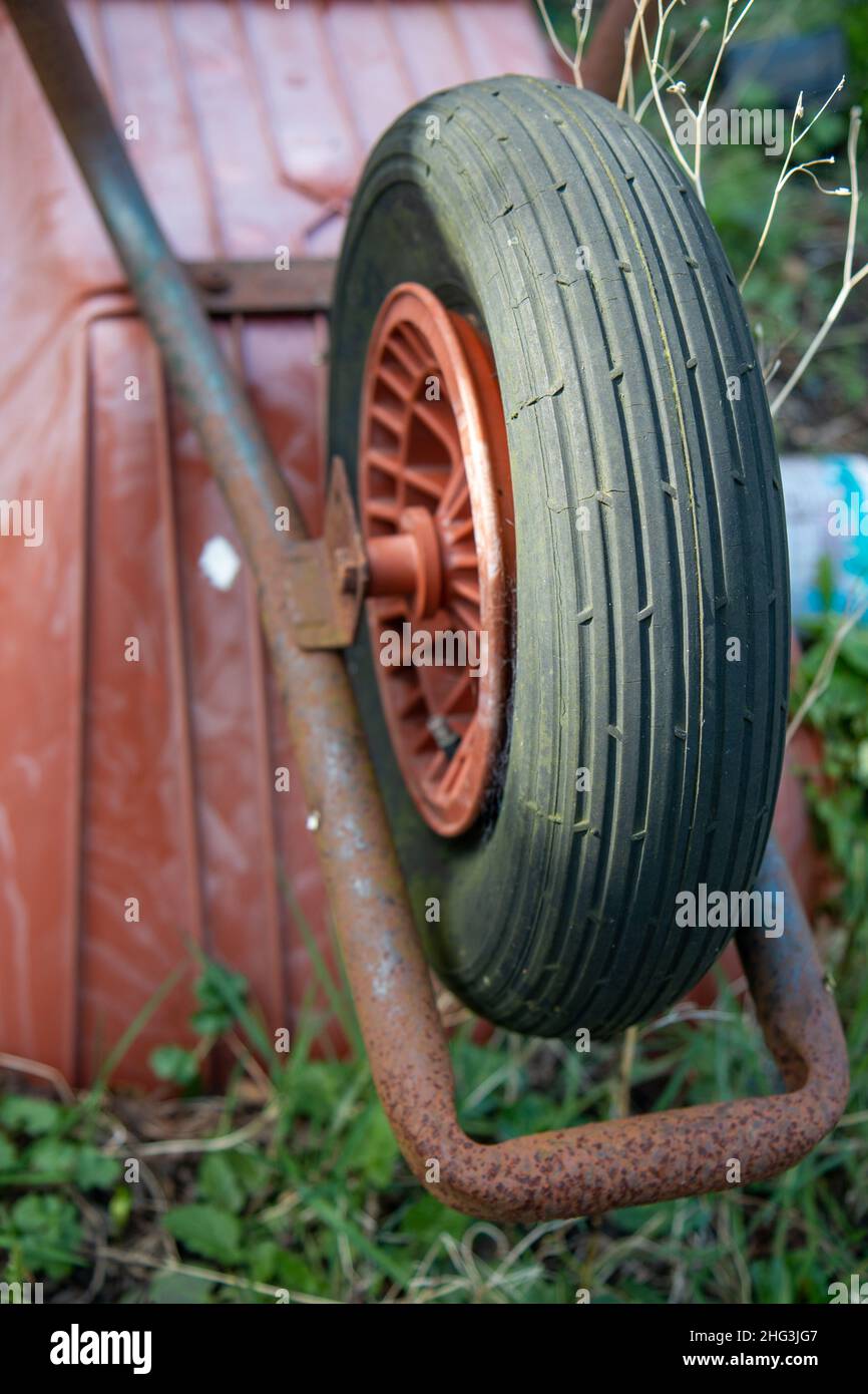 An old abandoned Rusty Wheelbarrow upside down in a garden Stock Photo ...