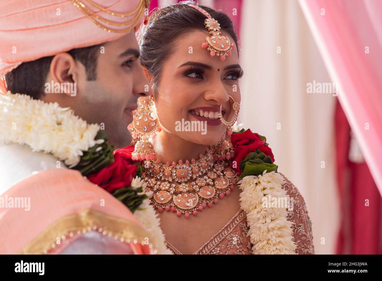 Portrait of beautiful bride and handsome groom during wedding ceremony ...