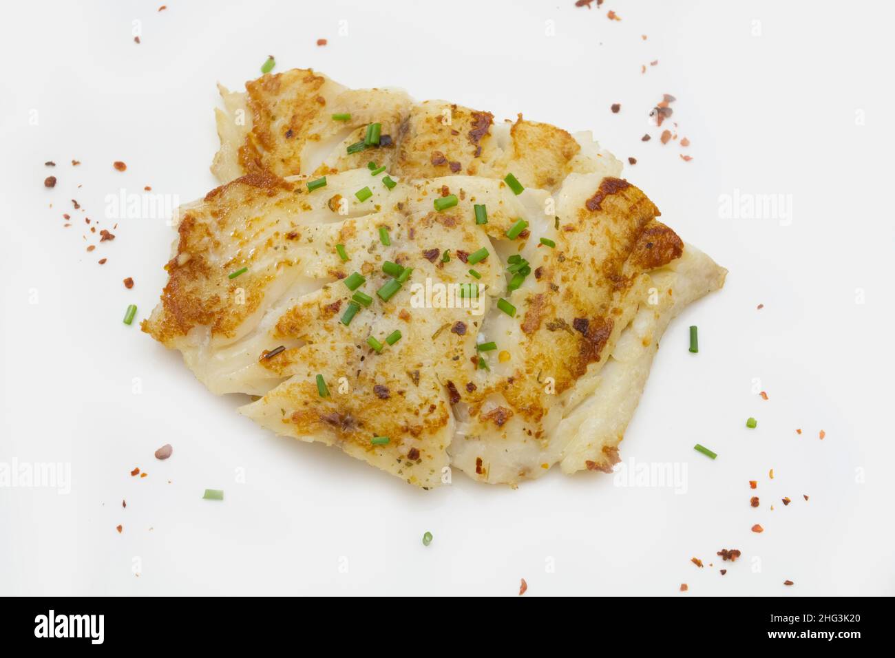 piece of cod with spices on a white background Stock Photo - Alamy