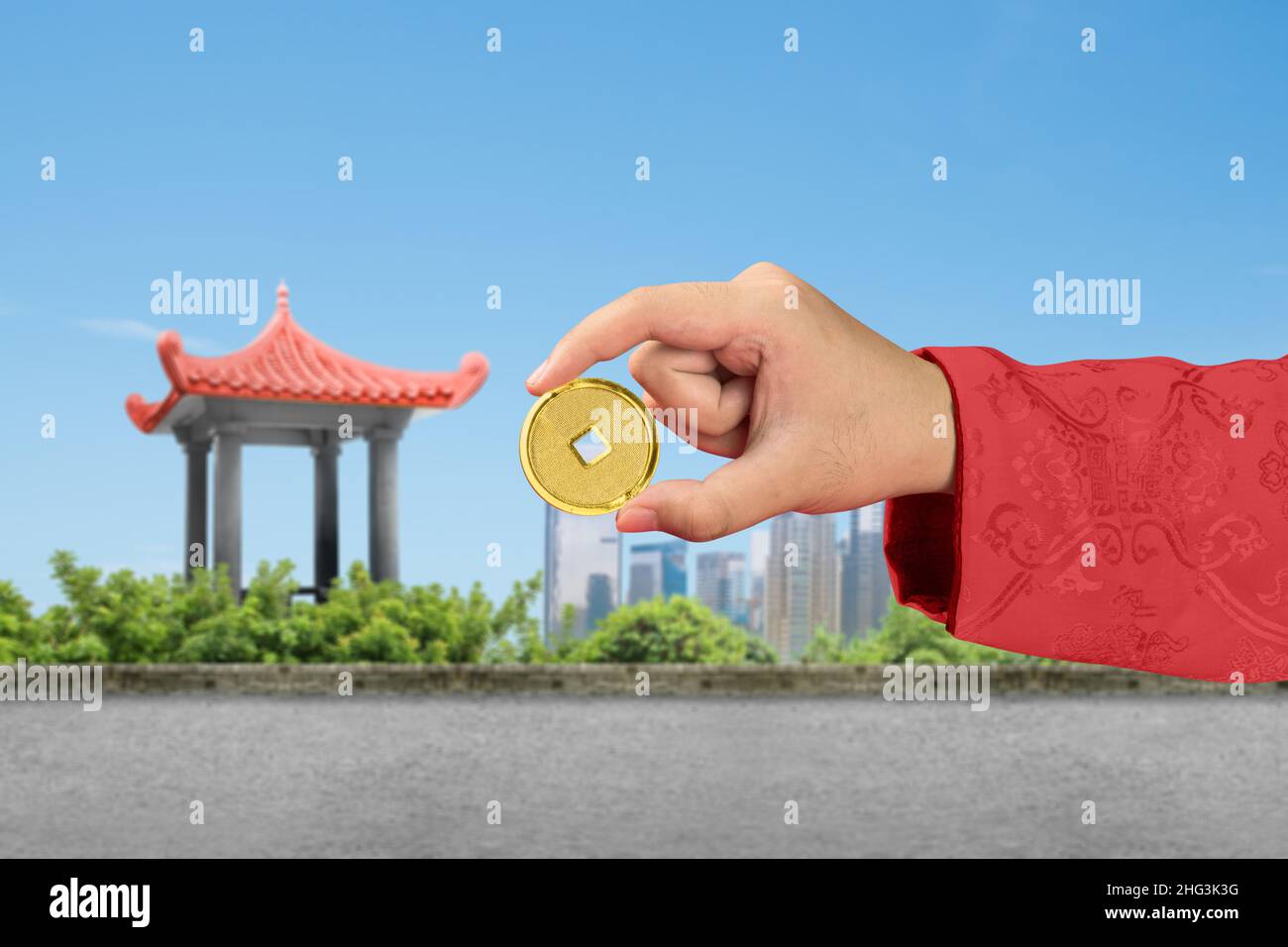 Hand holding golden Chinese coin with park background. Happy Chinese ...