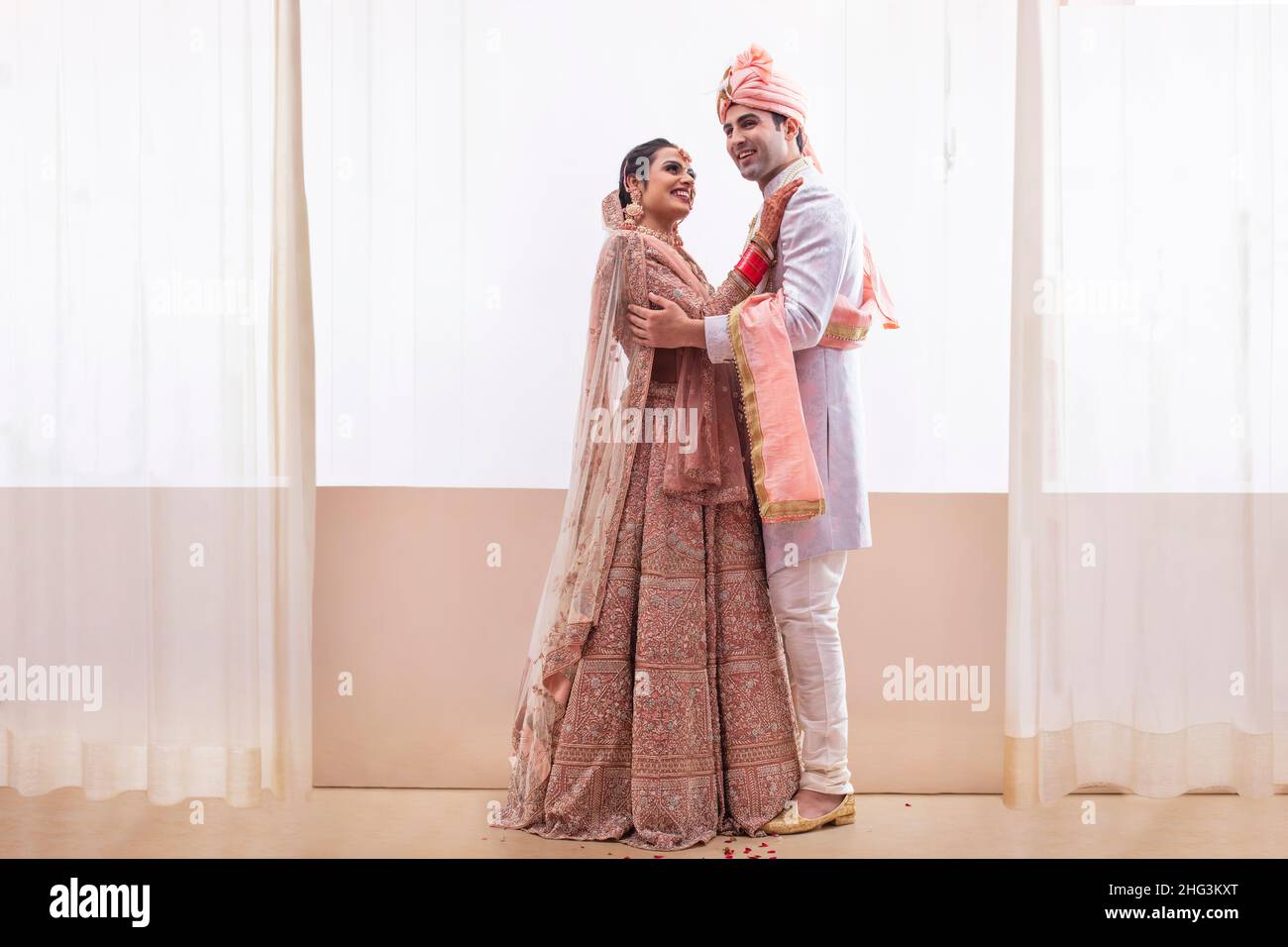 Happy married couple standing and smiling together Stock Photo - Alamy