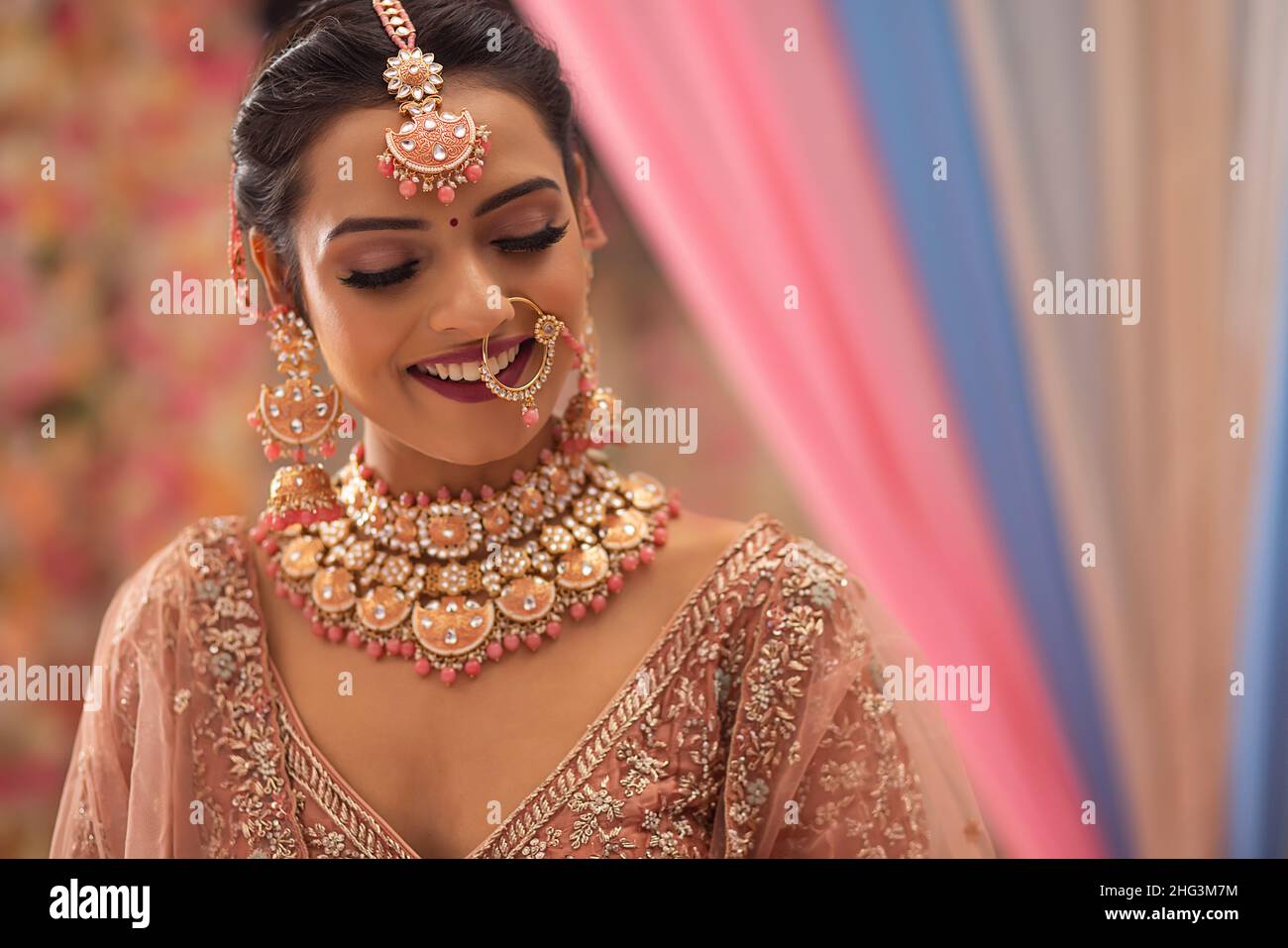 Portrait of beautiful smiling Indian bride in traditional wedding ...