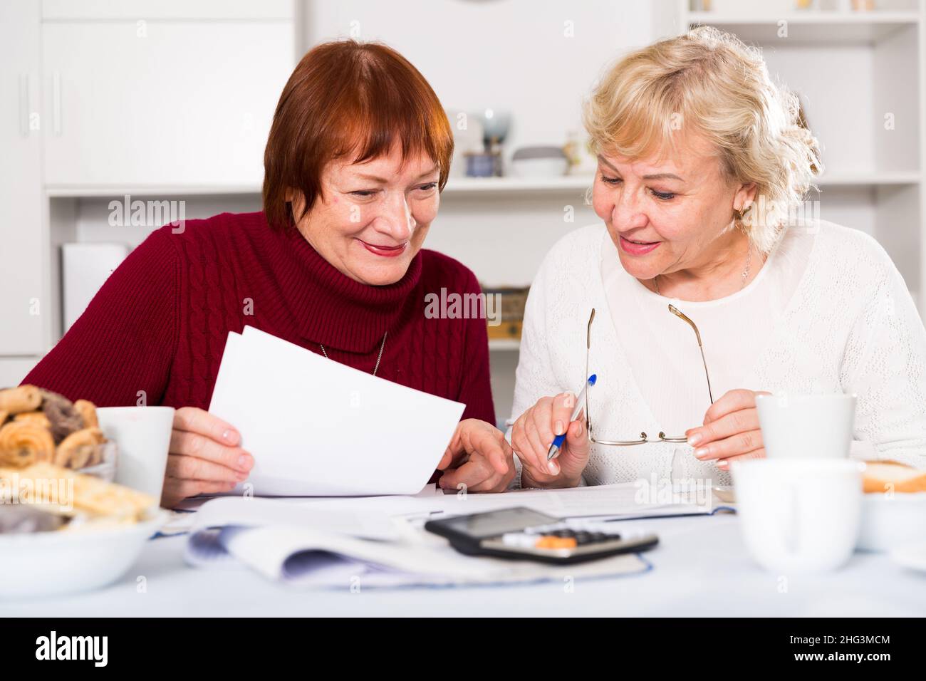 Cheerful elderly women with documents Stock Photo - Alamy