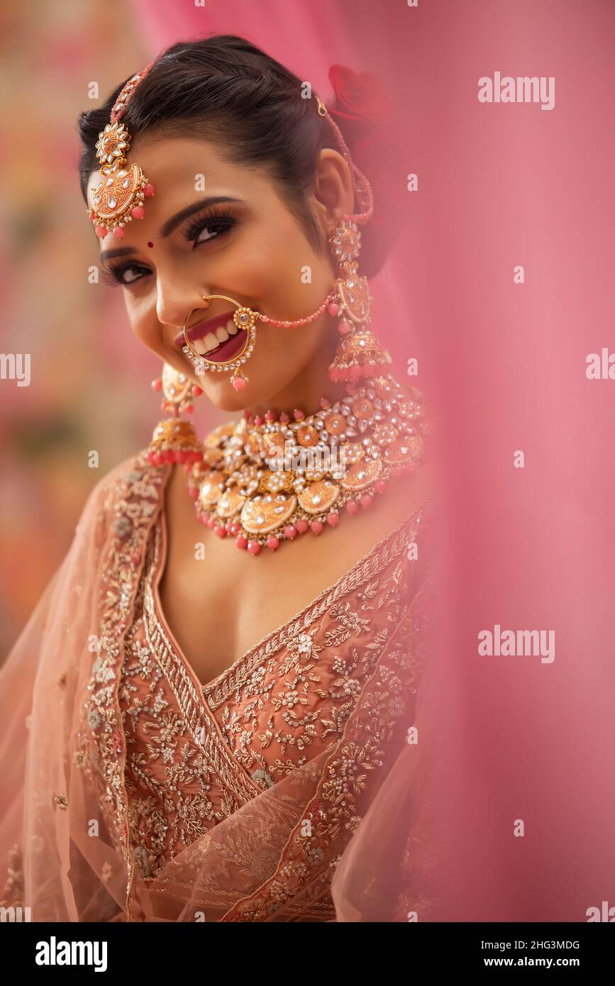 Portrait of an attractive Indian bride posing with smile Stock Photo ...