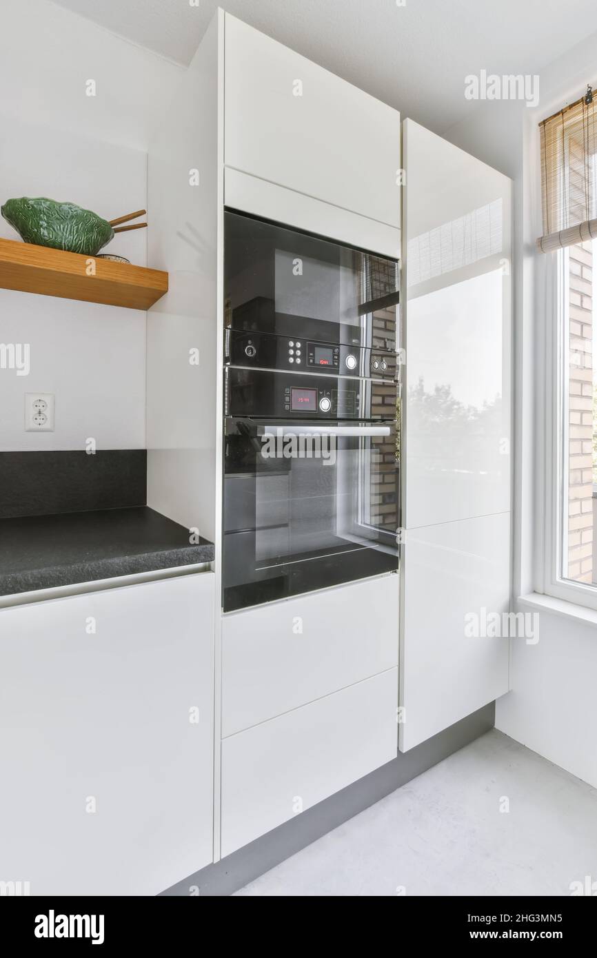 Gorgeous modern oven built into the kitchen unit Stock Photo - Alamy