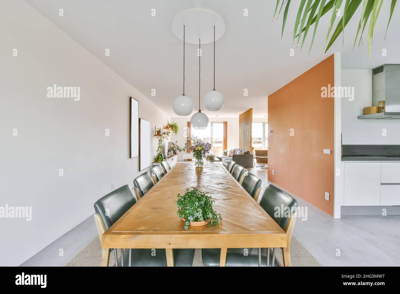 Magnificent large dining area with a long table and a vase of flowers ...