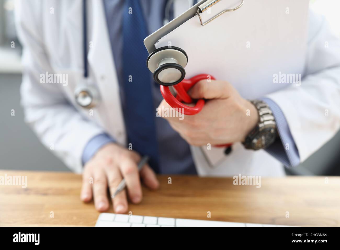 Doctor holding medical equipment red stethoscope and patient medical ...