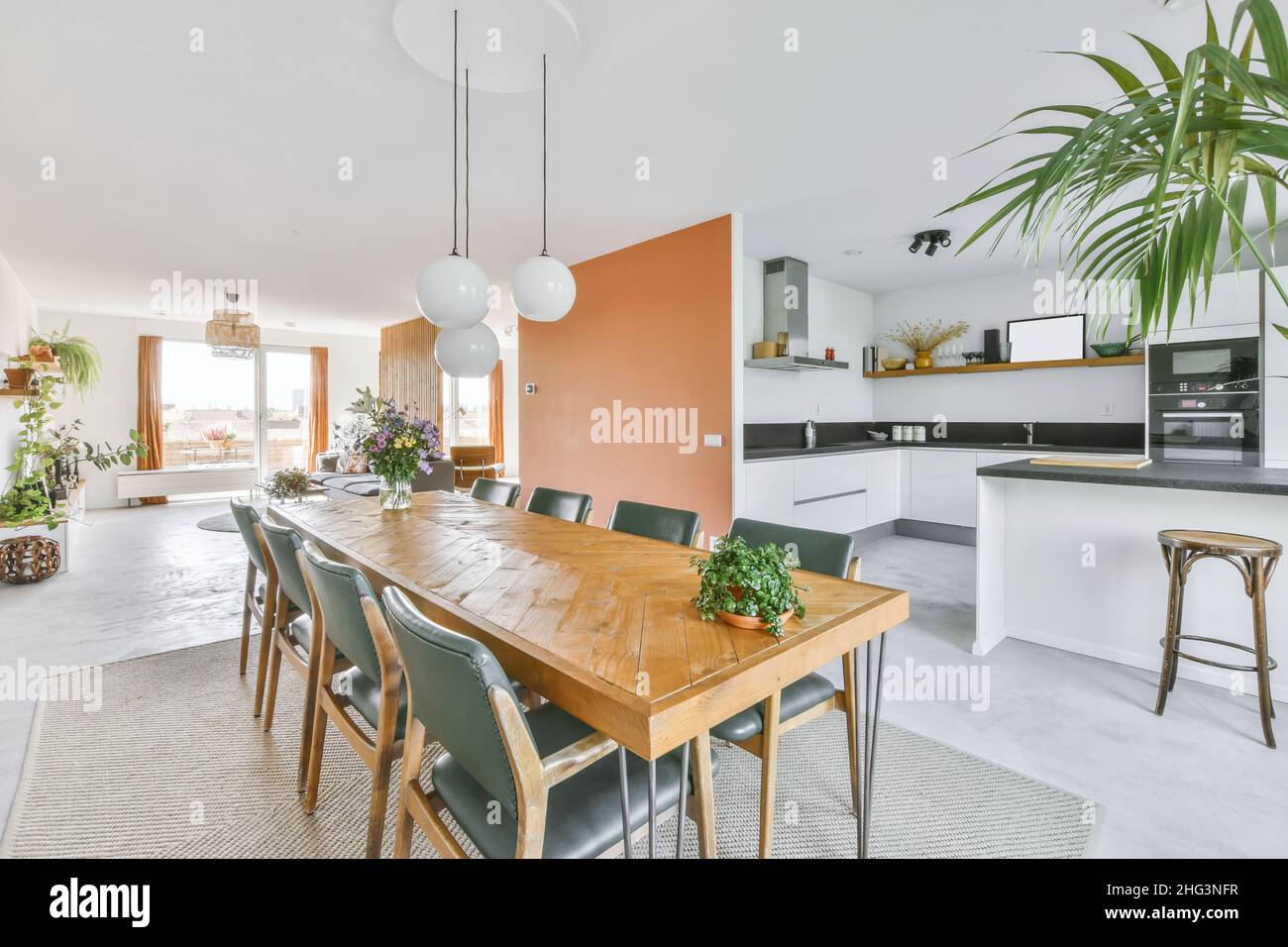Magnificent large dining area with a long table and a vase of flowers ...