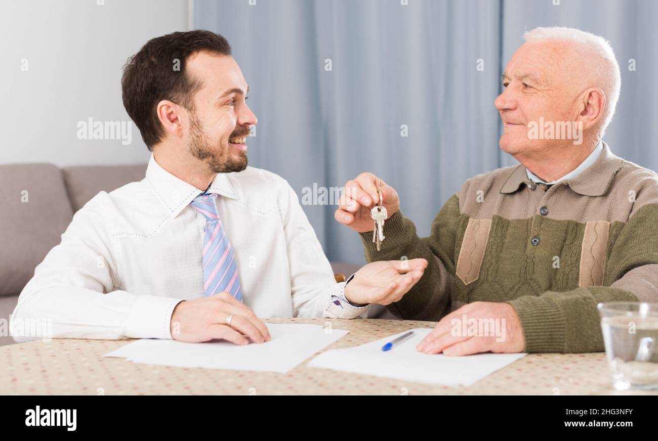 Elderly man and agent rent apartments Stock Photo - Alamy