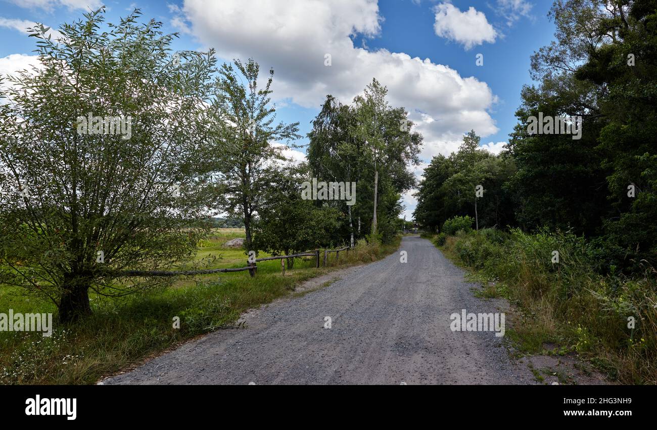 Panoramic photo of a gravel road at rural Europe. Suburban road path ...