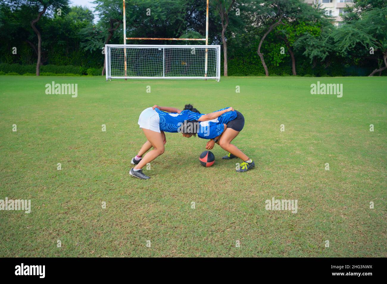 Two young athlete girls practicing rugby together on the field Stock ...