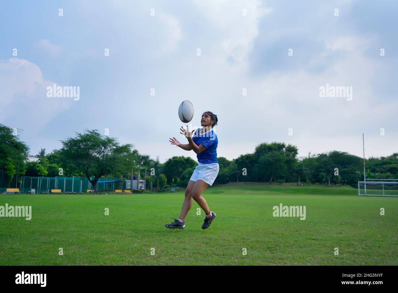 Young athlete girl practicing rugby on the sports field Stock Photo - Alamy