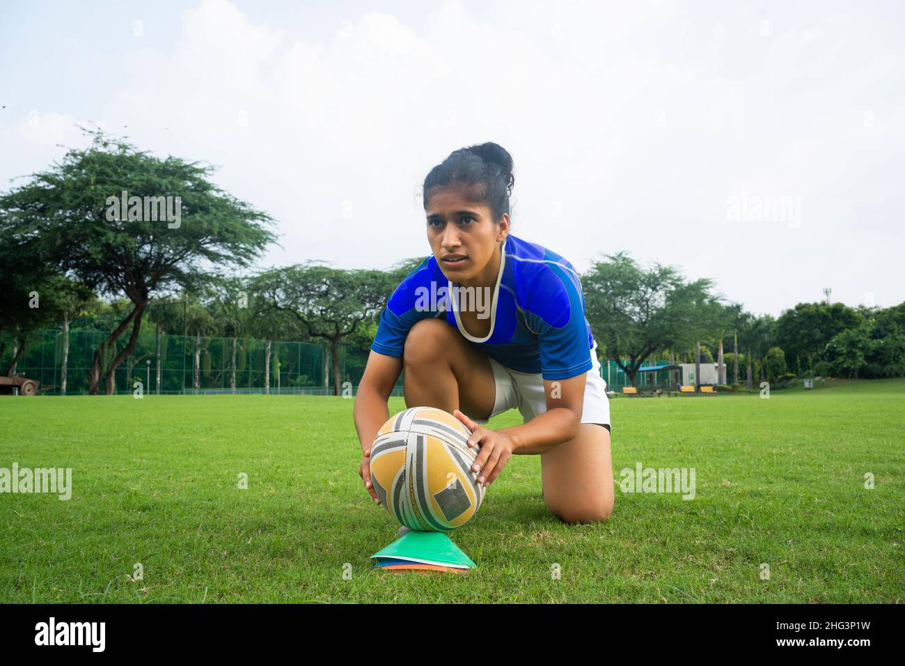 Young rugby player placing rugby ball on the grassy field Stock Photo ...