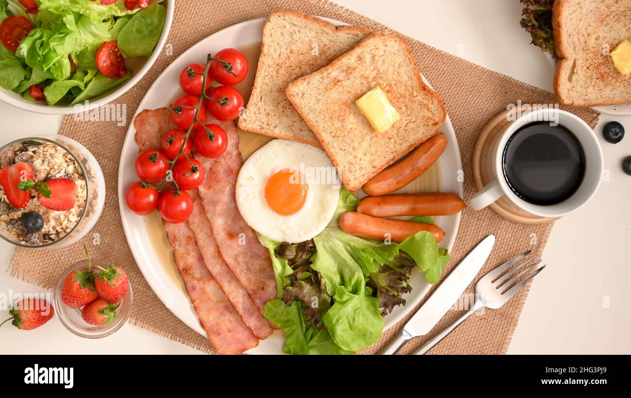 Top view of a hotel American breakfast set with egg, bacons, toasts ...