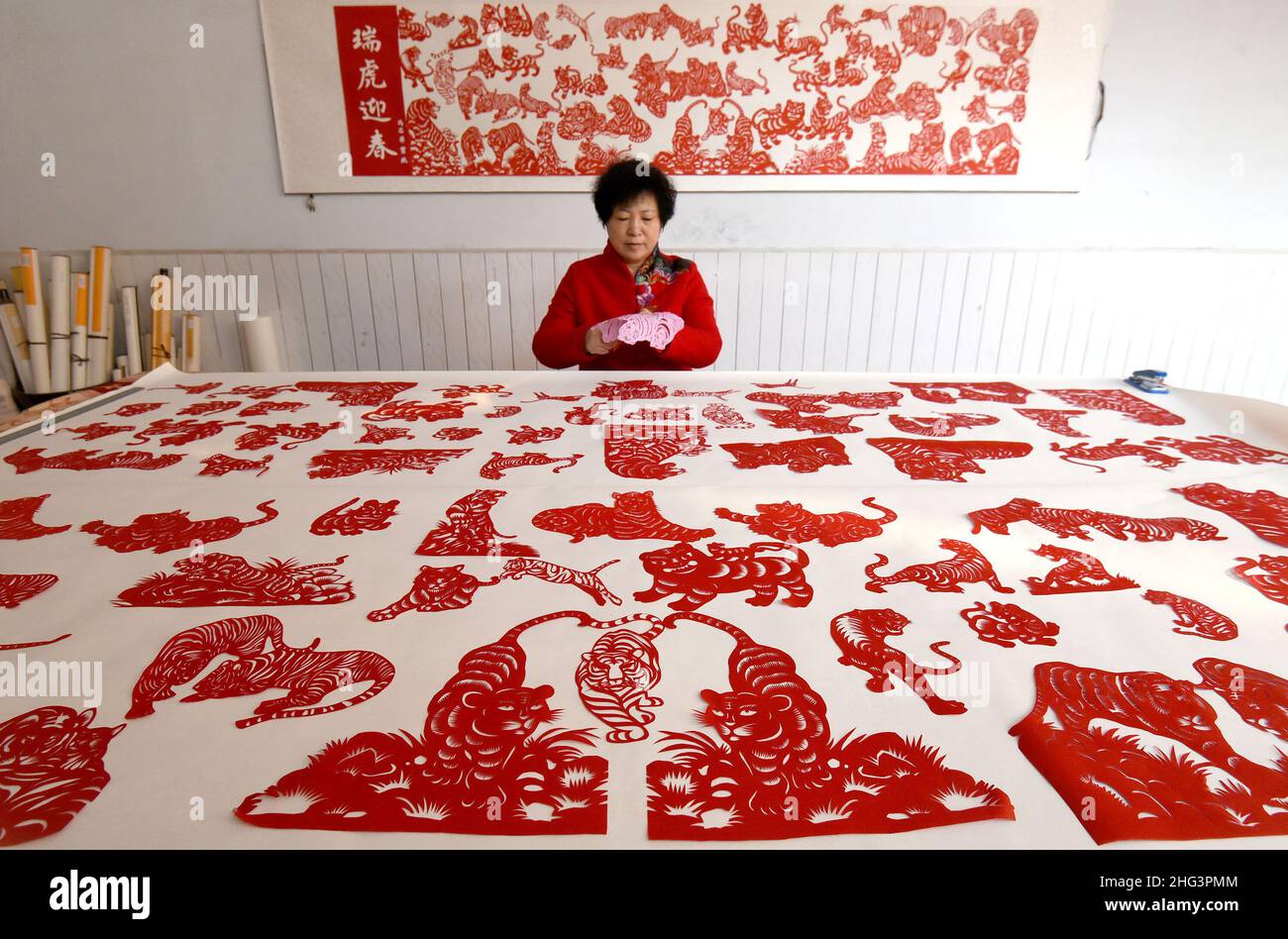 HANDAN, CHINA - JANUARY 18, 2022 - A folk paper cutting artist creates ...