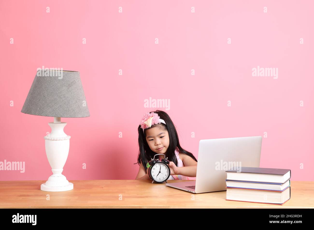 The cute Asian girl learning from internet by laptop with the pink ...