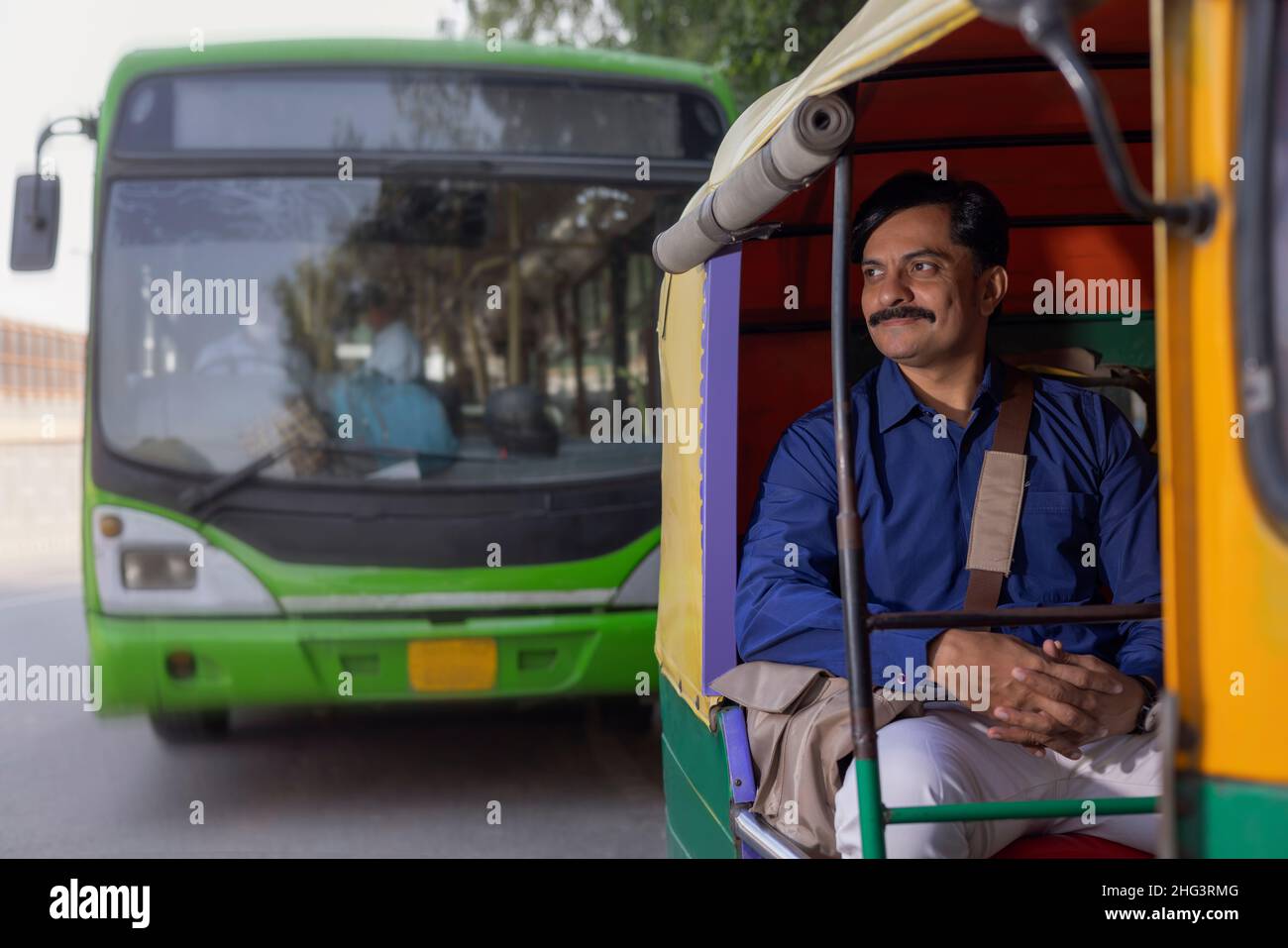 Man watching outside while going to office by Auto Rickshaw Stock Photo ...