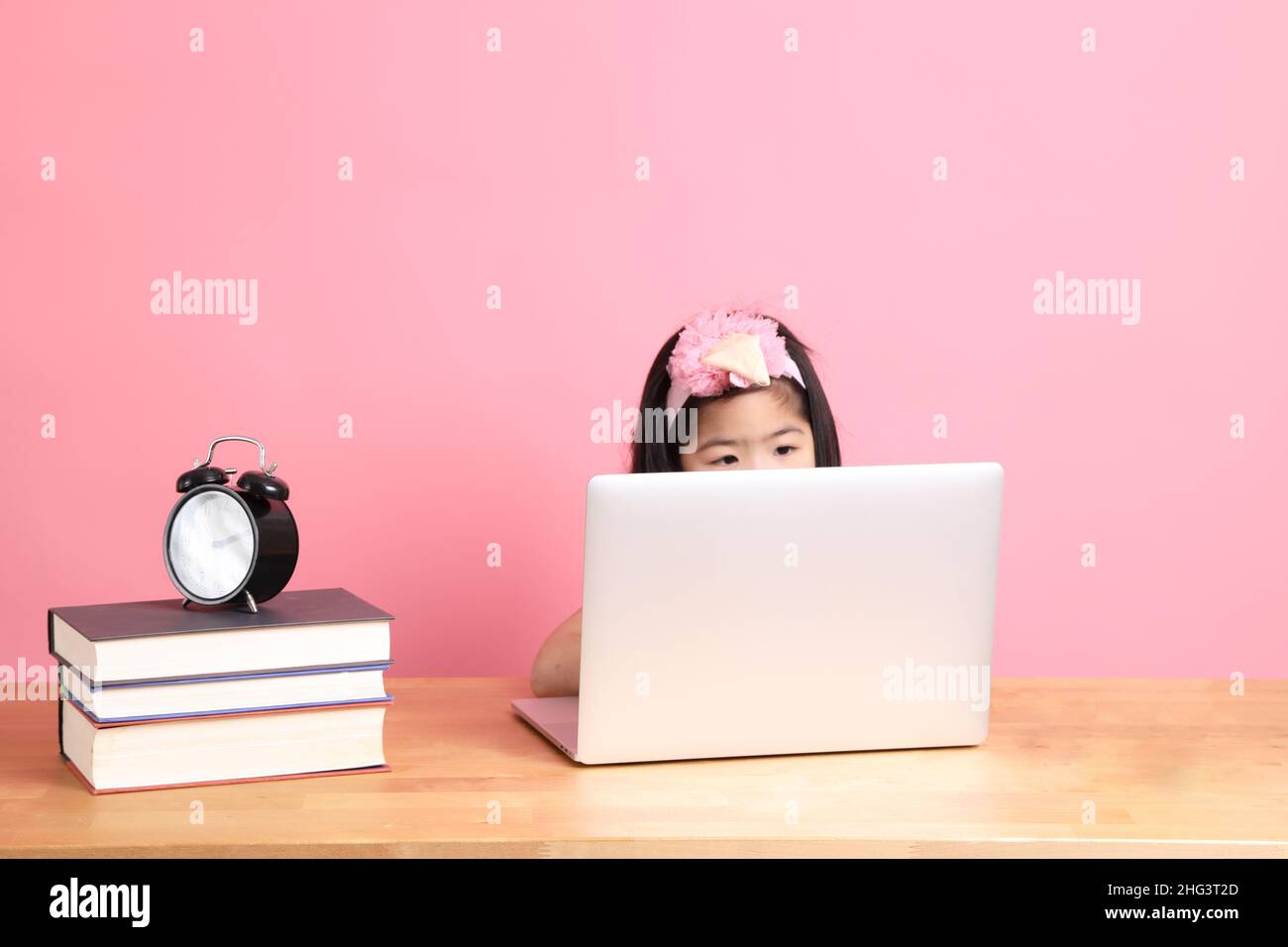 The cute Asian girl learning from internet by laptop with the pink ...
